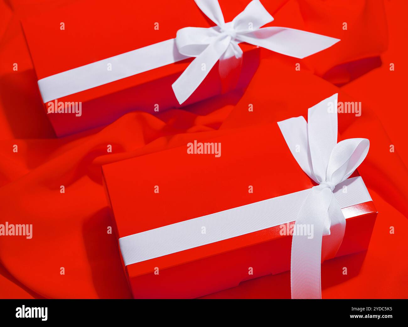 Red gifts on a yellow background Stock Photo - Alamy