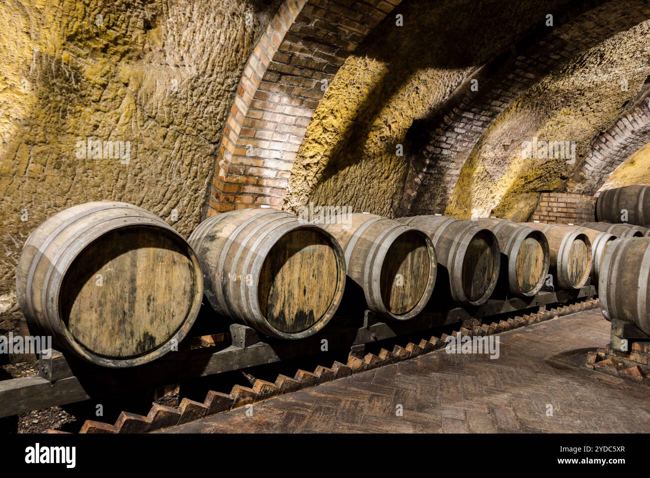 Red wine aging in oak barrels inside traditional winery cellar Stock ...