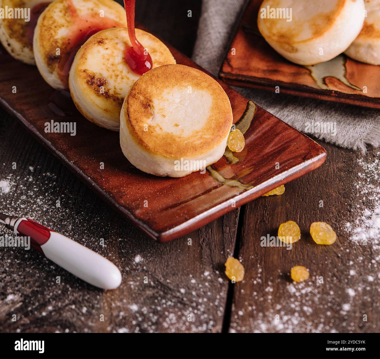 cottage cheese cakes poured with berry jam Stock Photo - Alamy