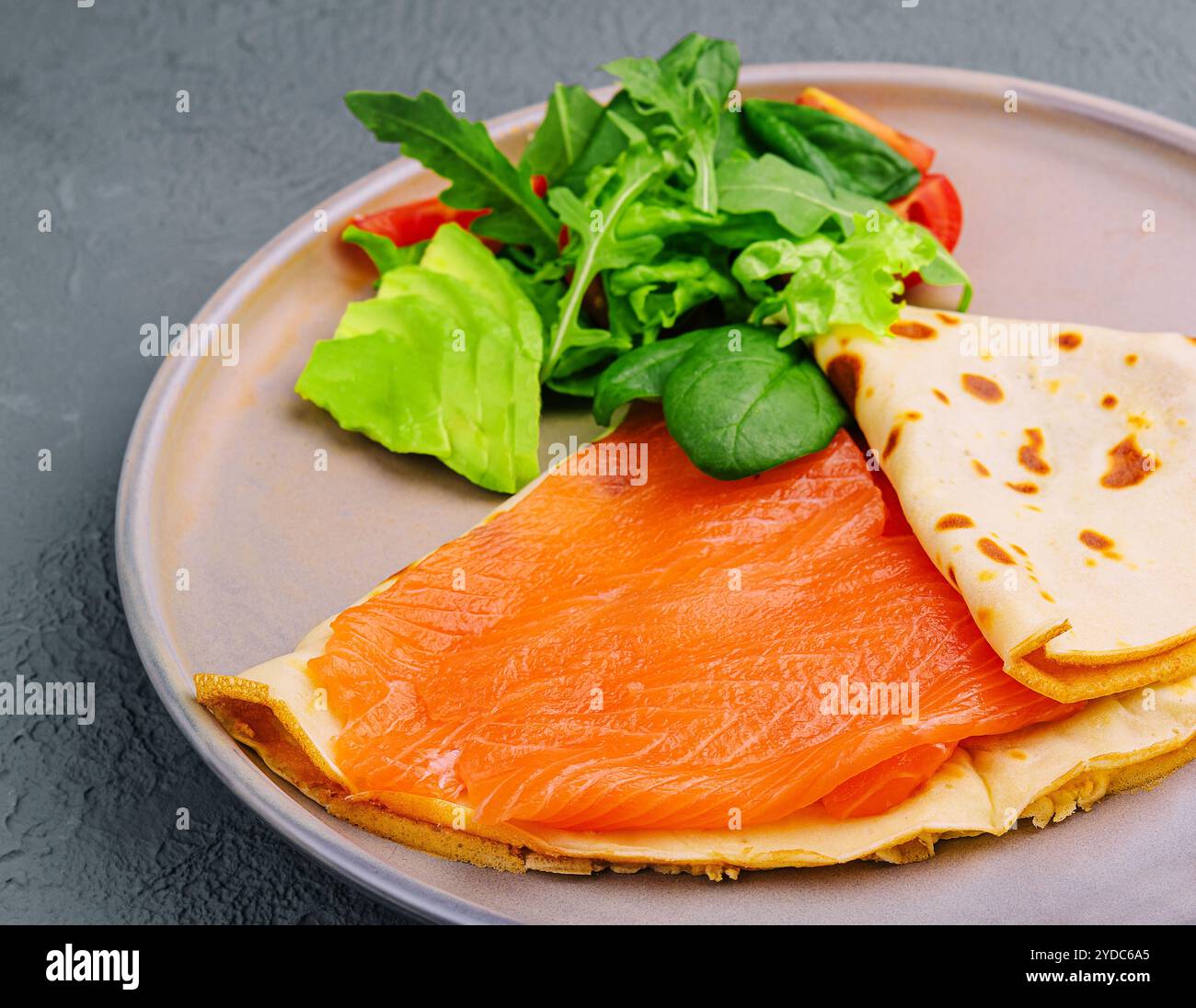 Pancake with red fish fillet on plate Stock Photo - Alamy
