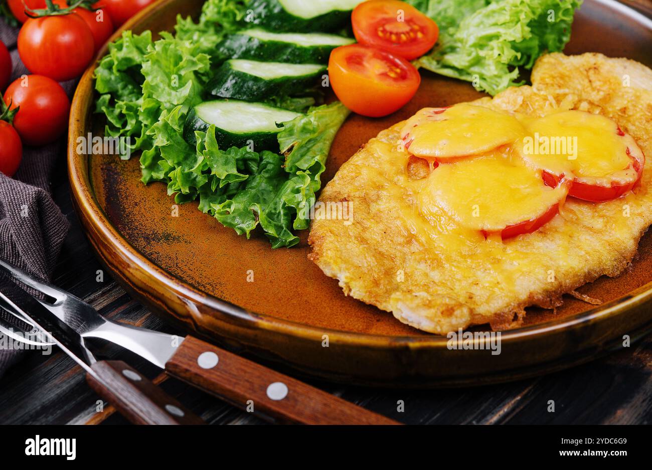 Fried chicken chop in cheese with tomatoes Stock Photo - Alamy