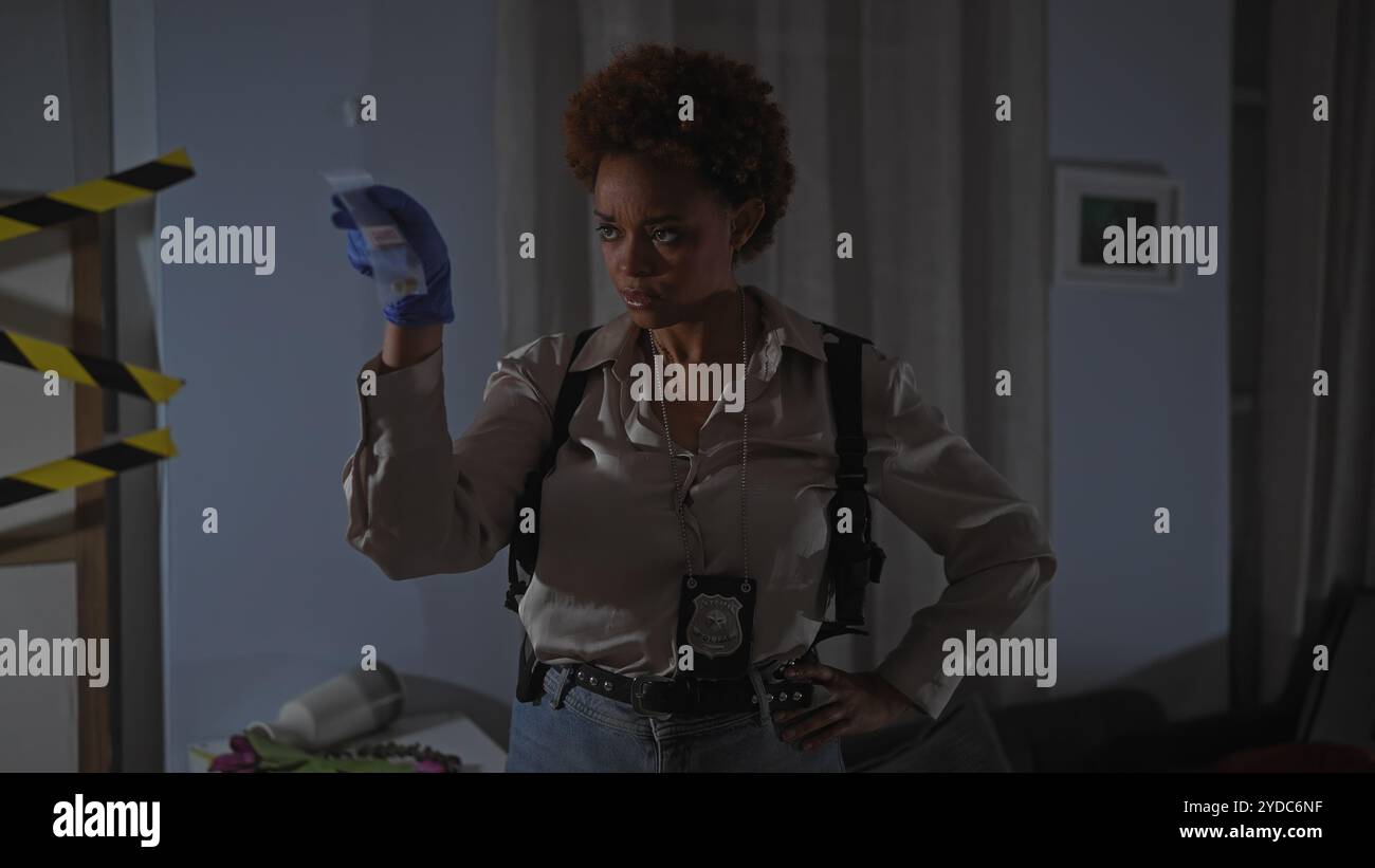 African american female detective analyzing evidence at crime scene ...