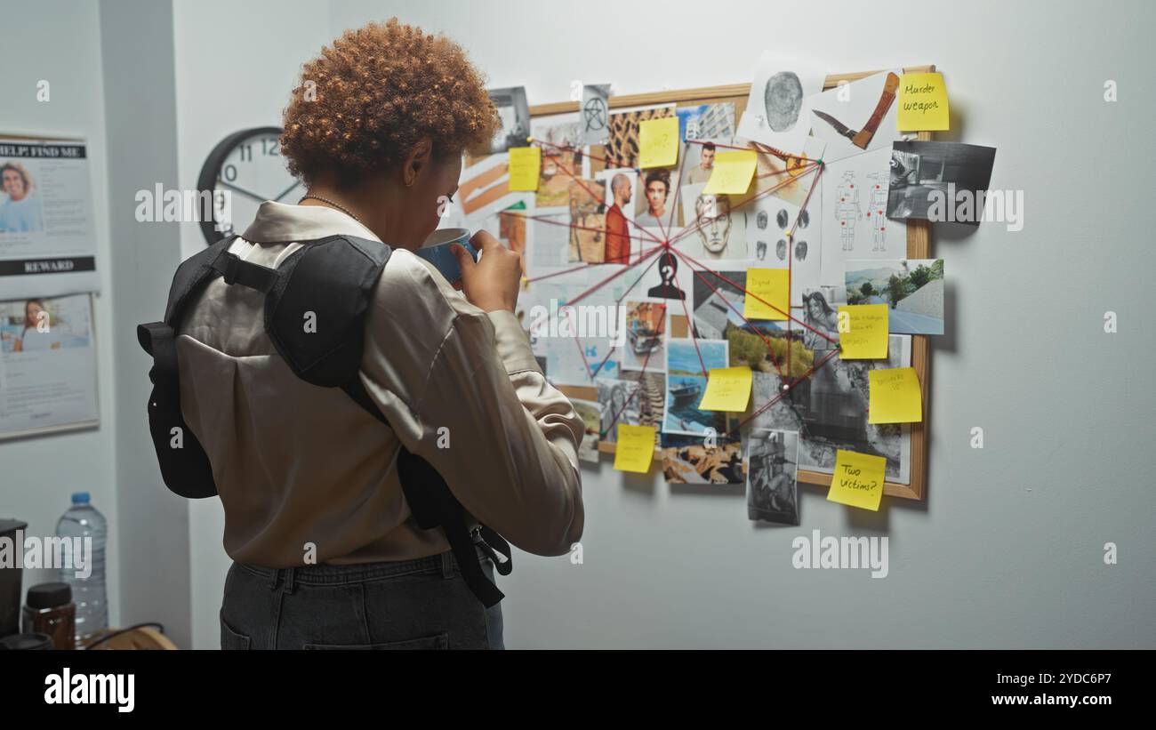 African american woman detective analyzing evidence on board at police ...