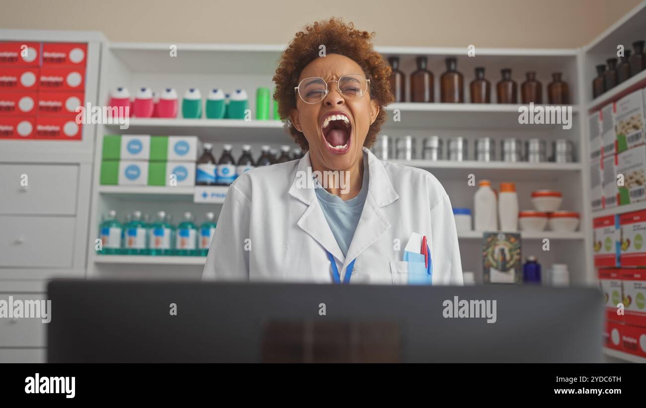 A distressed african american female pharmacist yells indoors at a ...