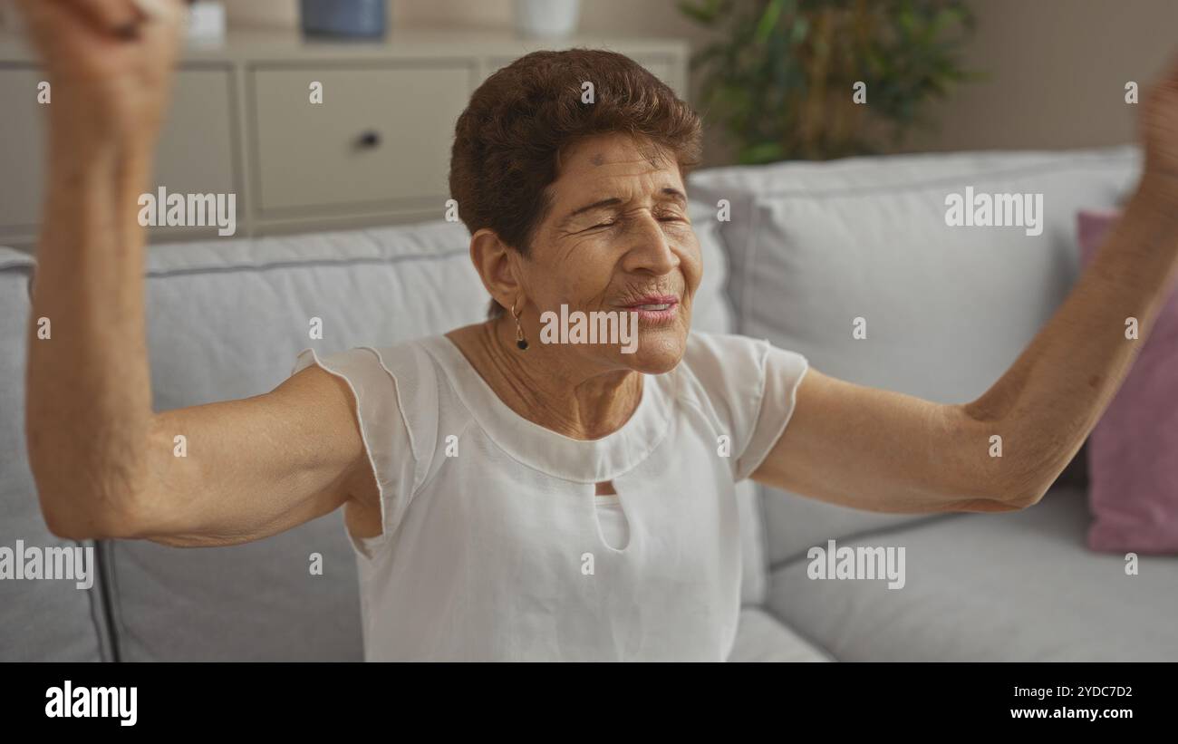 An elderly hispanic woman with short hair enjoys a moment in her living ...