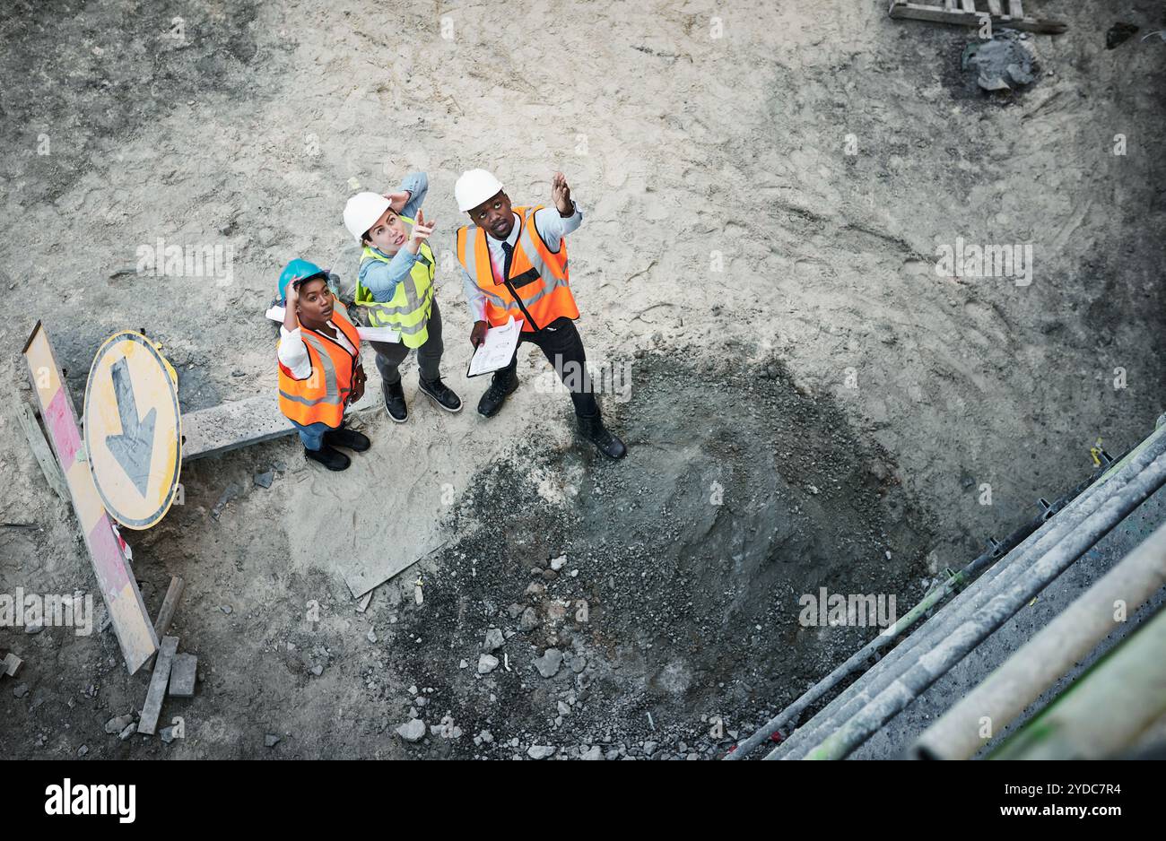 Tablet, construction site and people with pointing and above building ...