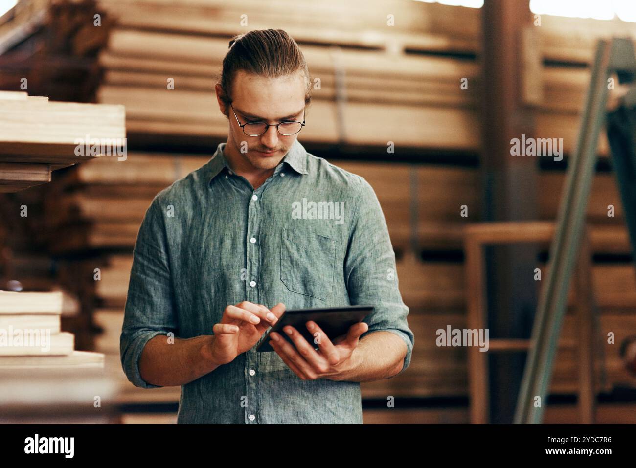 Carpentry, tablet and man with wood in workshop for manufacturing ...