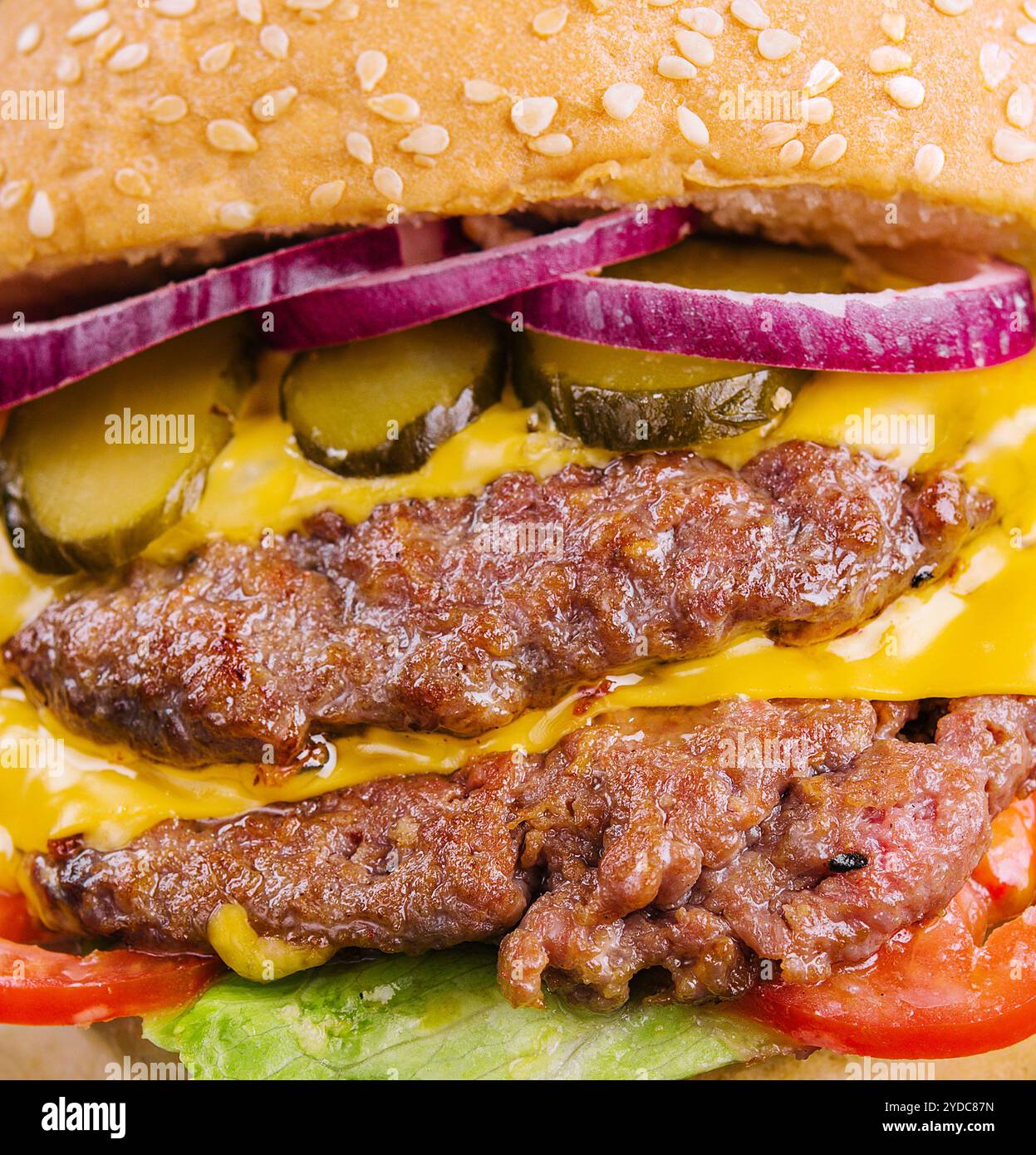 Double patty burger with pickles close up Stock Photo - Alamy
