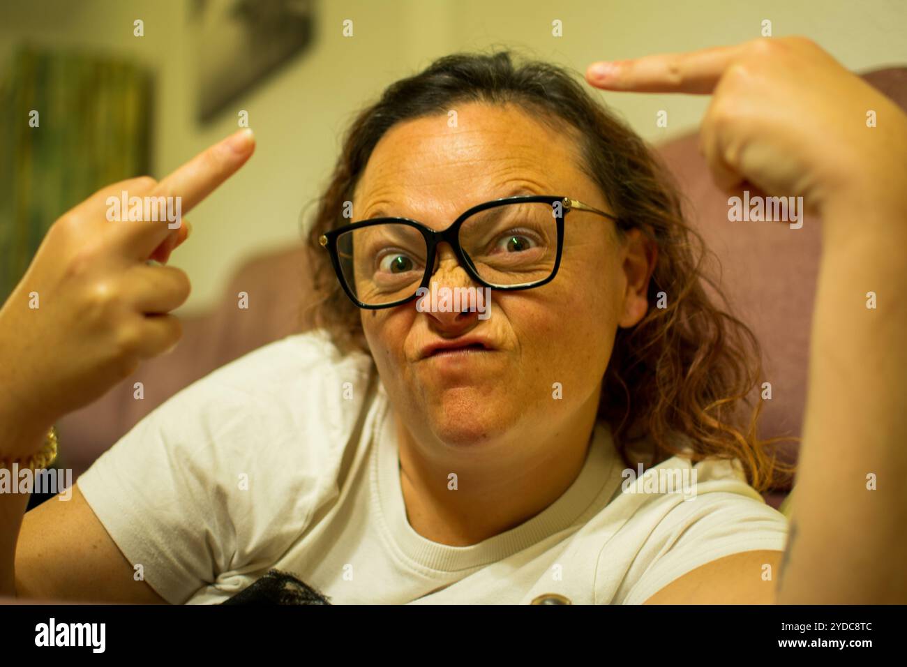 an old woman poses amused on camera showing both middle fingers Stock ...