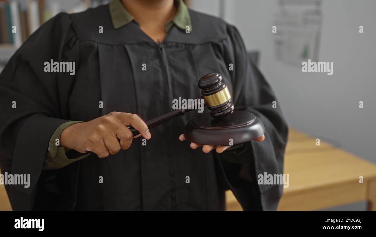 Woman judge holding gavel in office, courtroom setting illustrating ...
