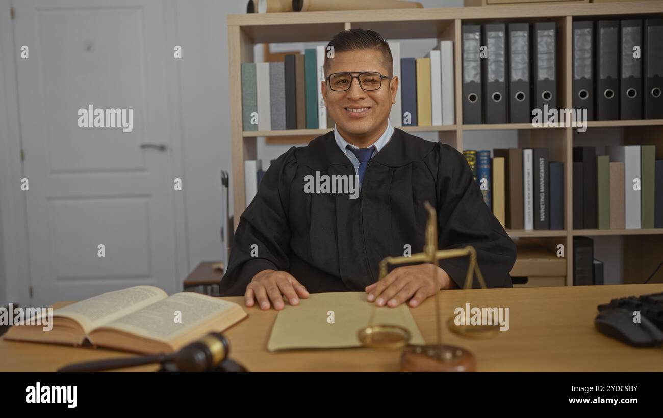 Young man in a courtroom setting, wearing a judge's robe, sitting at a ...