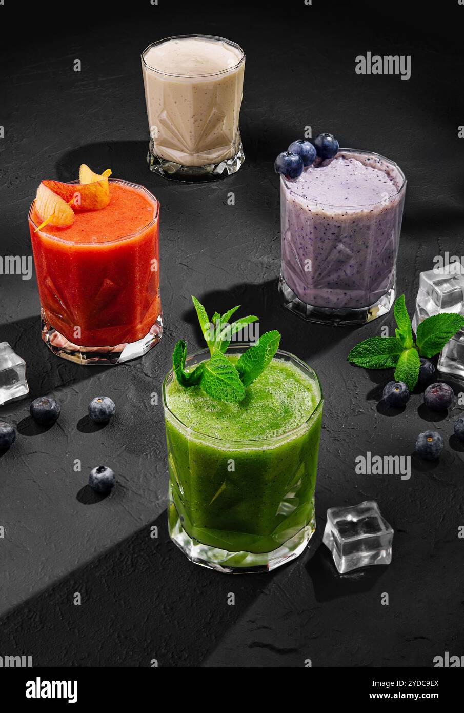 Freshly blended fruit smoothies of various colors and tastes in glass ...