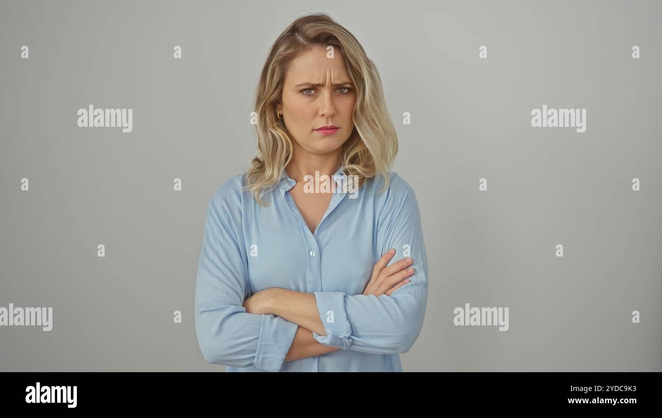 Portrait of a displeased young caucasian woman with blonde hair wearing ...