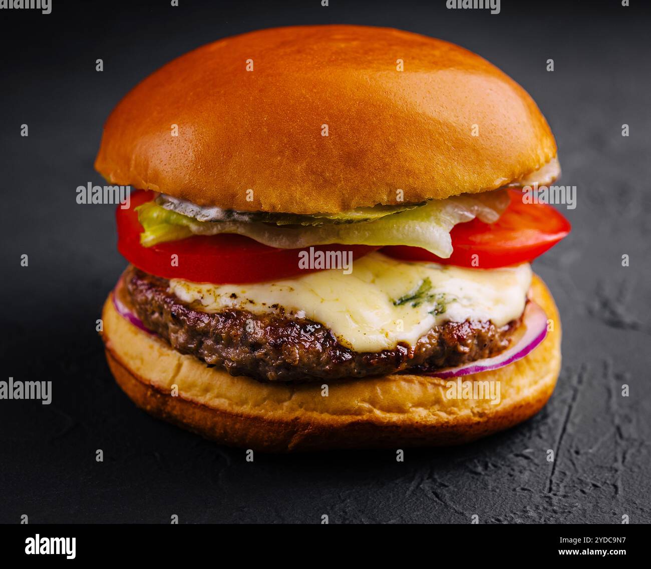 Delicious cheeseburger on a black background Stock Photo - Alamy