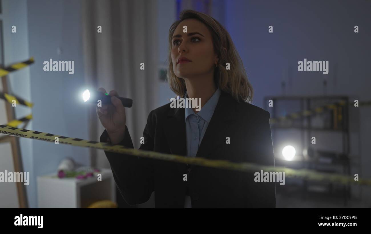 A serious young blonde woman investigates a crime scene indoors ...