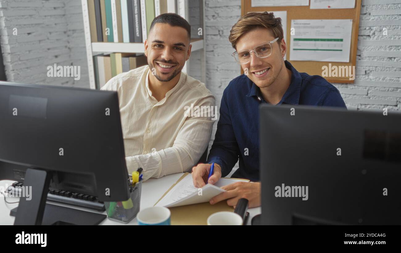 Handsome men working together at modern office with computers and ...