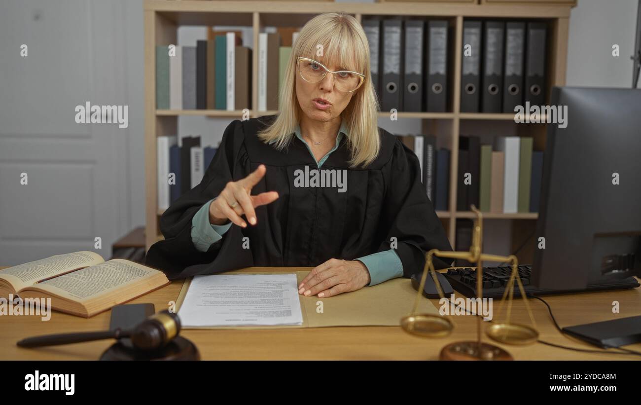 Woman judge working in a courtroom office focused on legal documents ...