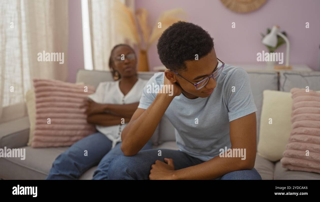 Mother and son having a serious discussion in a cozy living room at ...