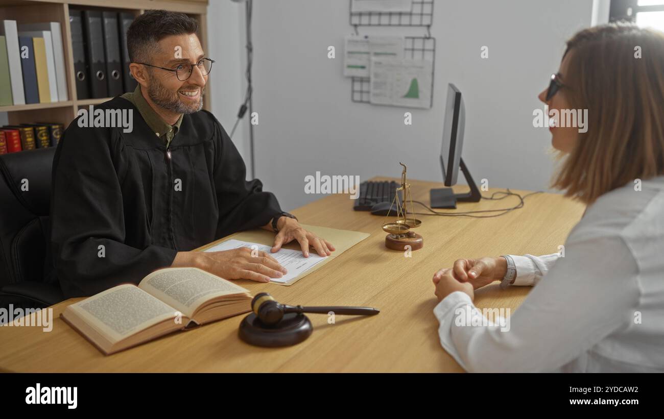 Man judge talking to woman client in office filled with books and legal ...