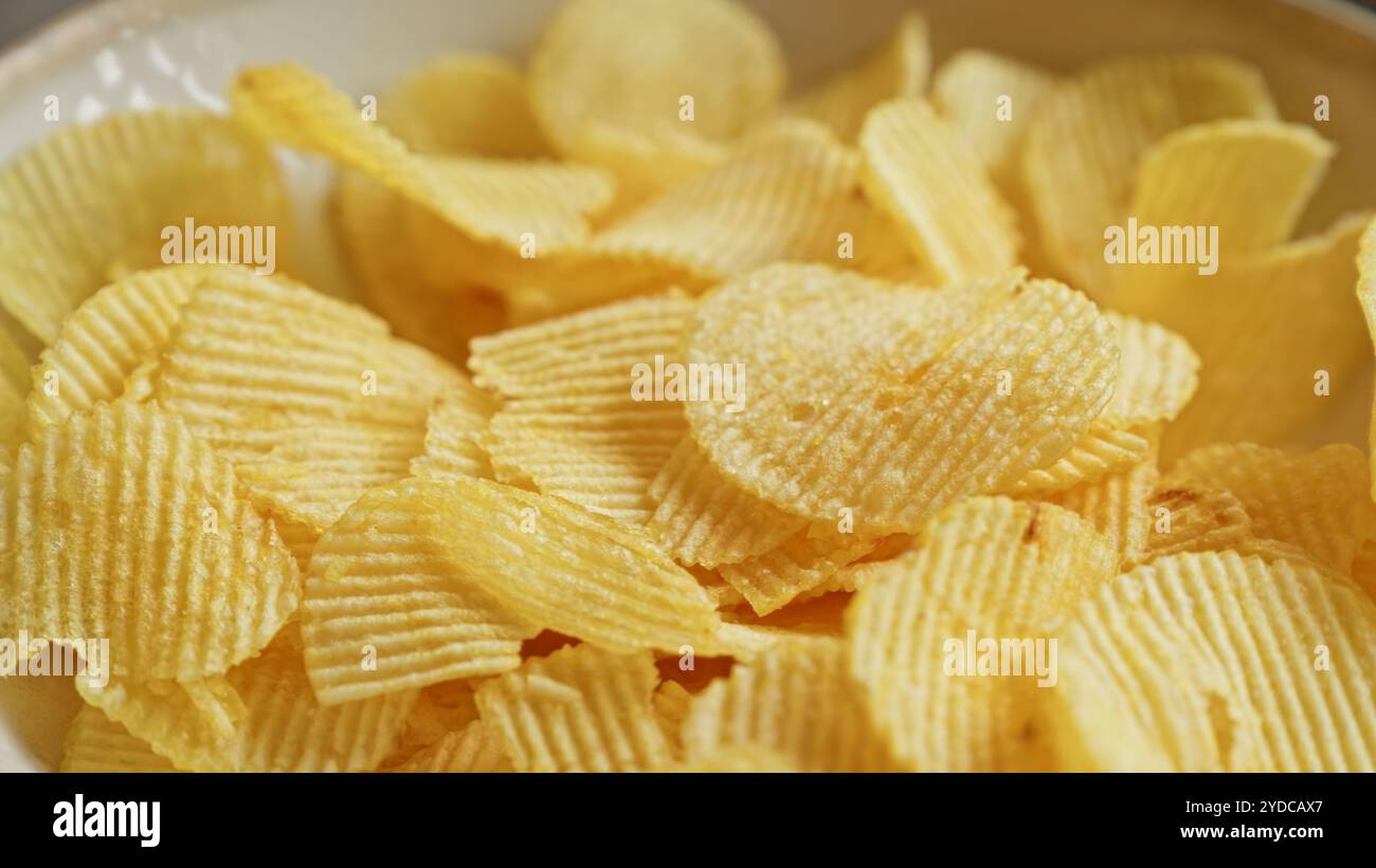 Crispy potato chips fill a bowl creating a delicious snack image ...