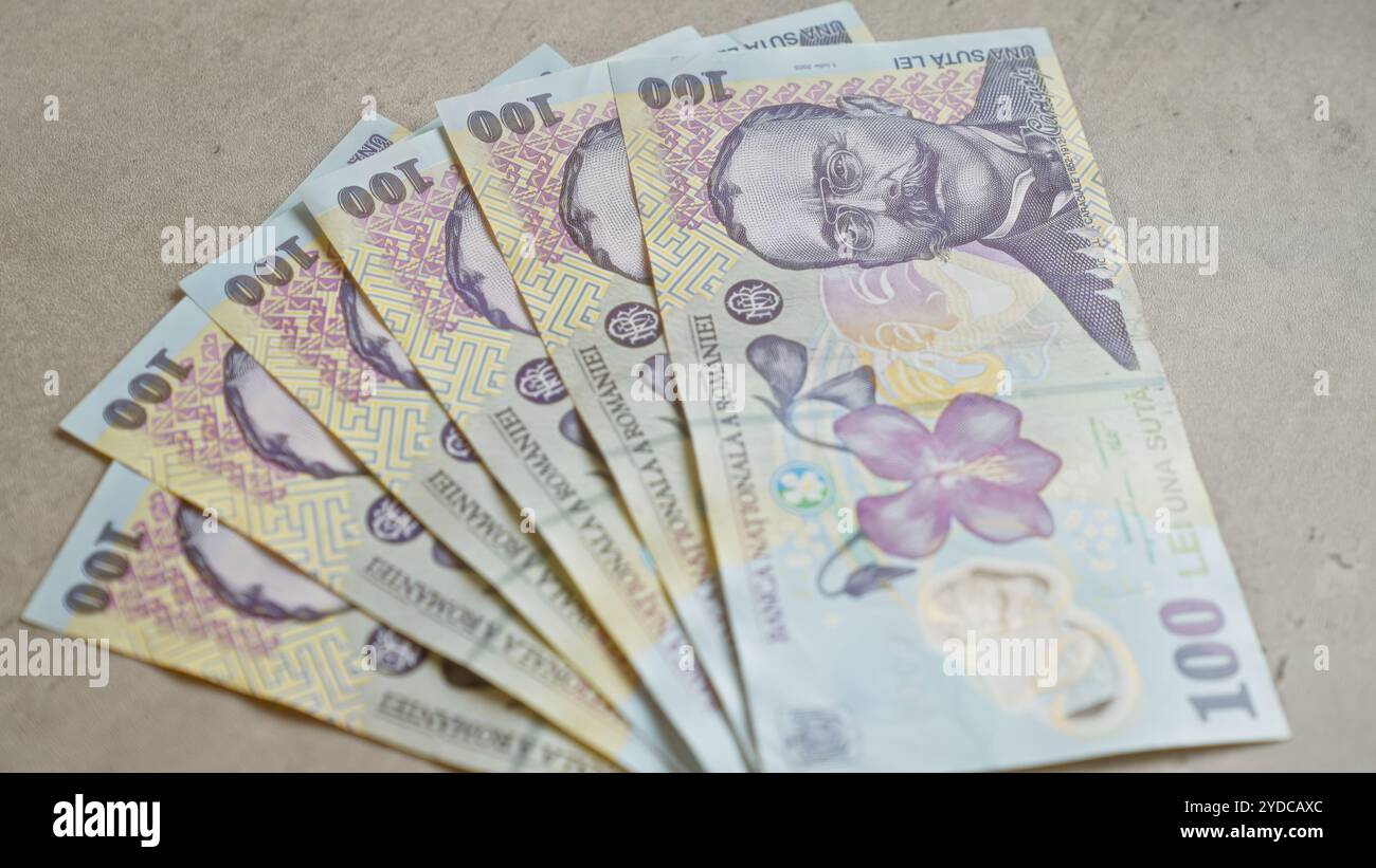 Romanian banknotes laid out on a concrete background showcasing leu ...