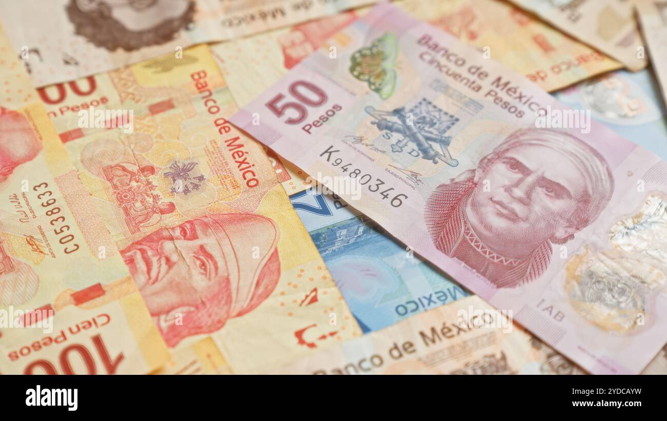 Mexican banknotes scattered with various denominations showing the ...