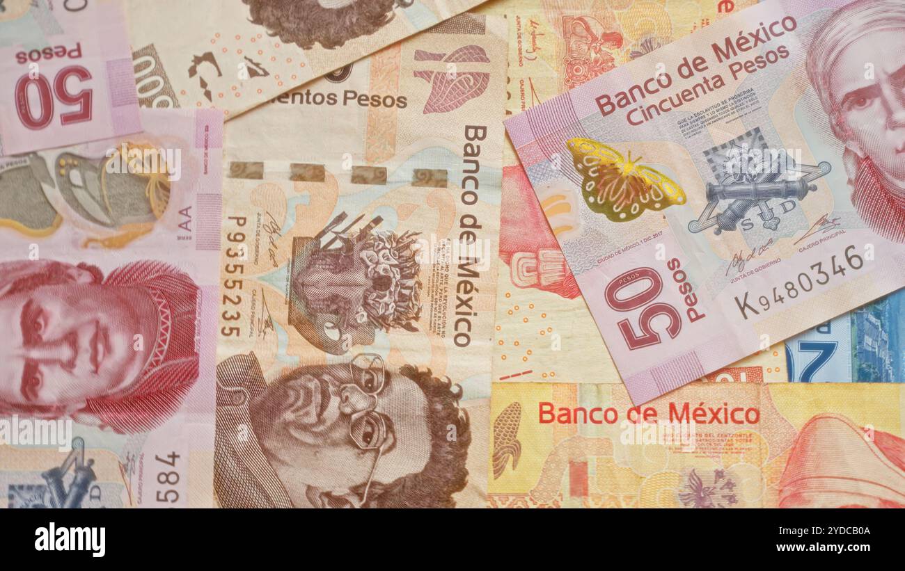 Mexican pesos banknotes of various denominations spread out in a ...