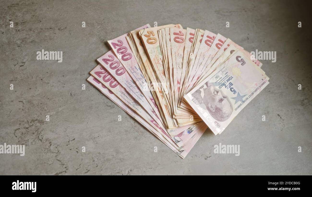Turkish lira banknotes fanned out on a concrete surface showcasing ...