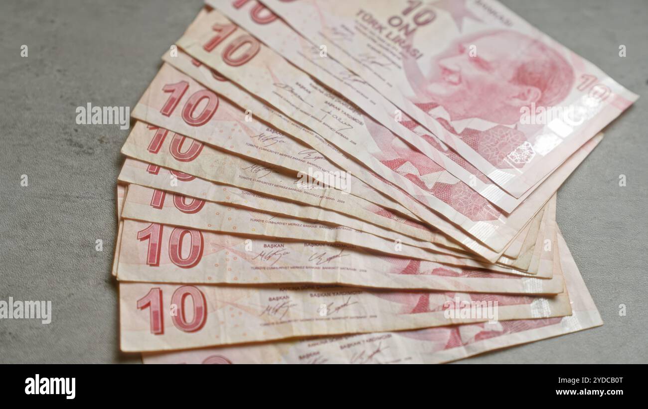 Turkish banknotes scattered on a concrete surface showcasing multiple ...