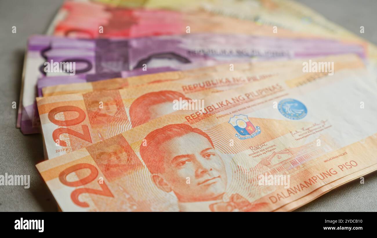 Philippine pesos displayed on a concrete surface showcasing colorful ...