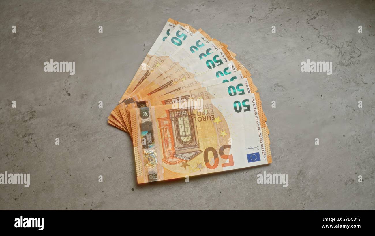 Euro banknotes arranged on concrete surface, highlighting european ...