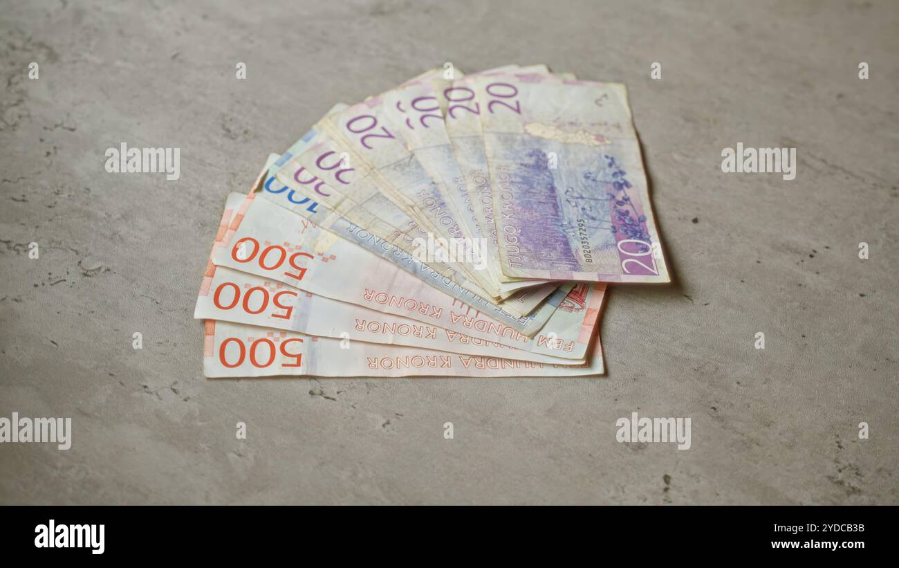 Swedish krona banknotes spread out on a concrete surface showcasing ...