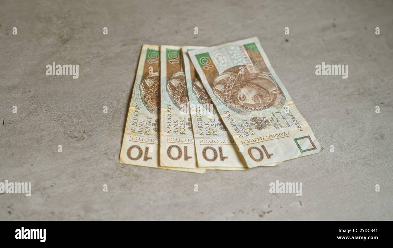 Polish banknotes in ten zloty denominations are neatly arranged on a ...