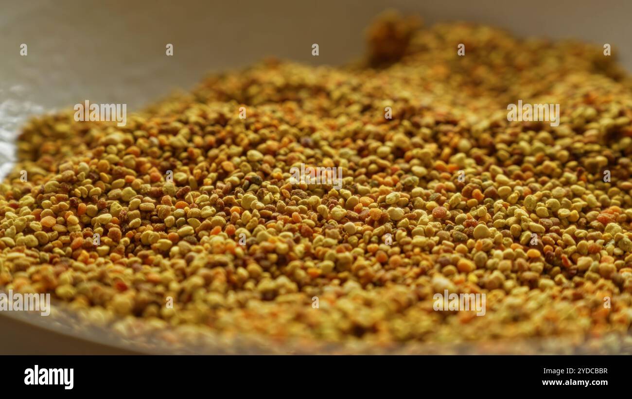 Macro photograph showing a close-up of dried, yellow, bee pollen grains ...