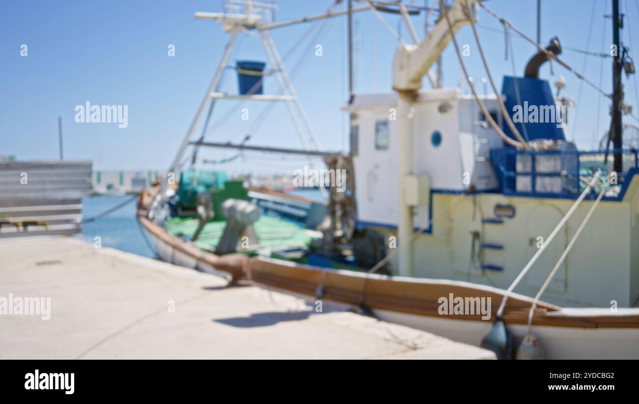 Blurred view of a docked fishing boat with a defocused background and ...