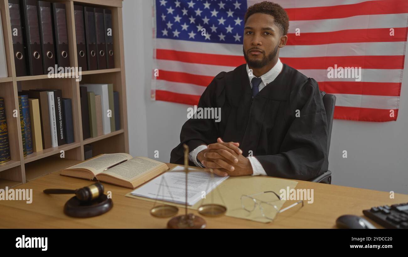 Young man in formal judicial attire sitting in an office with the ...