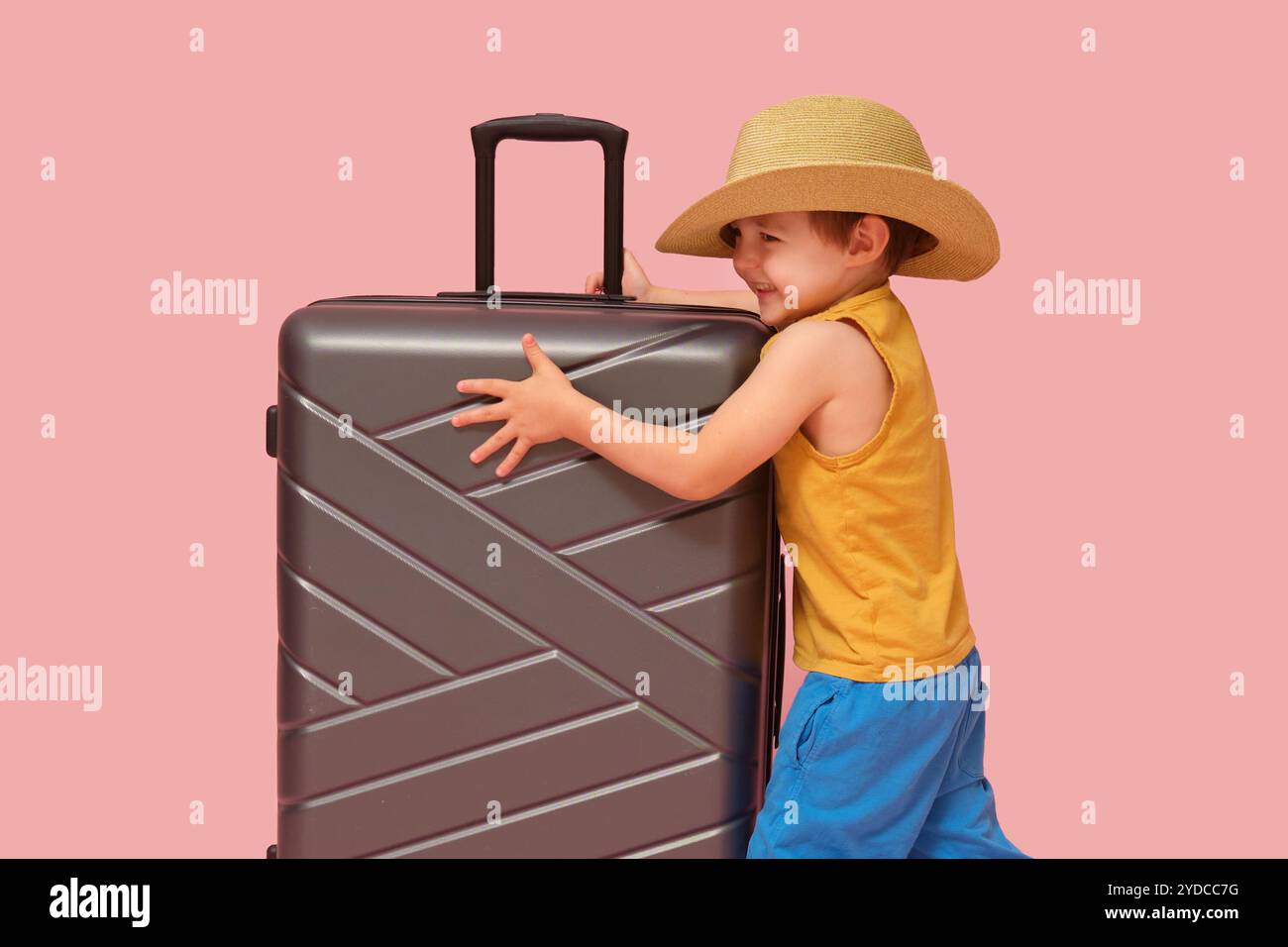 A cheerful child is dragging a bag of luggage, excited for the upcoming ...