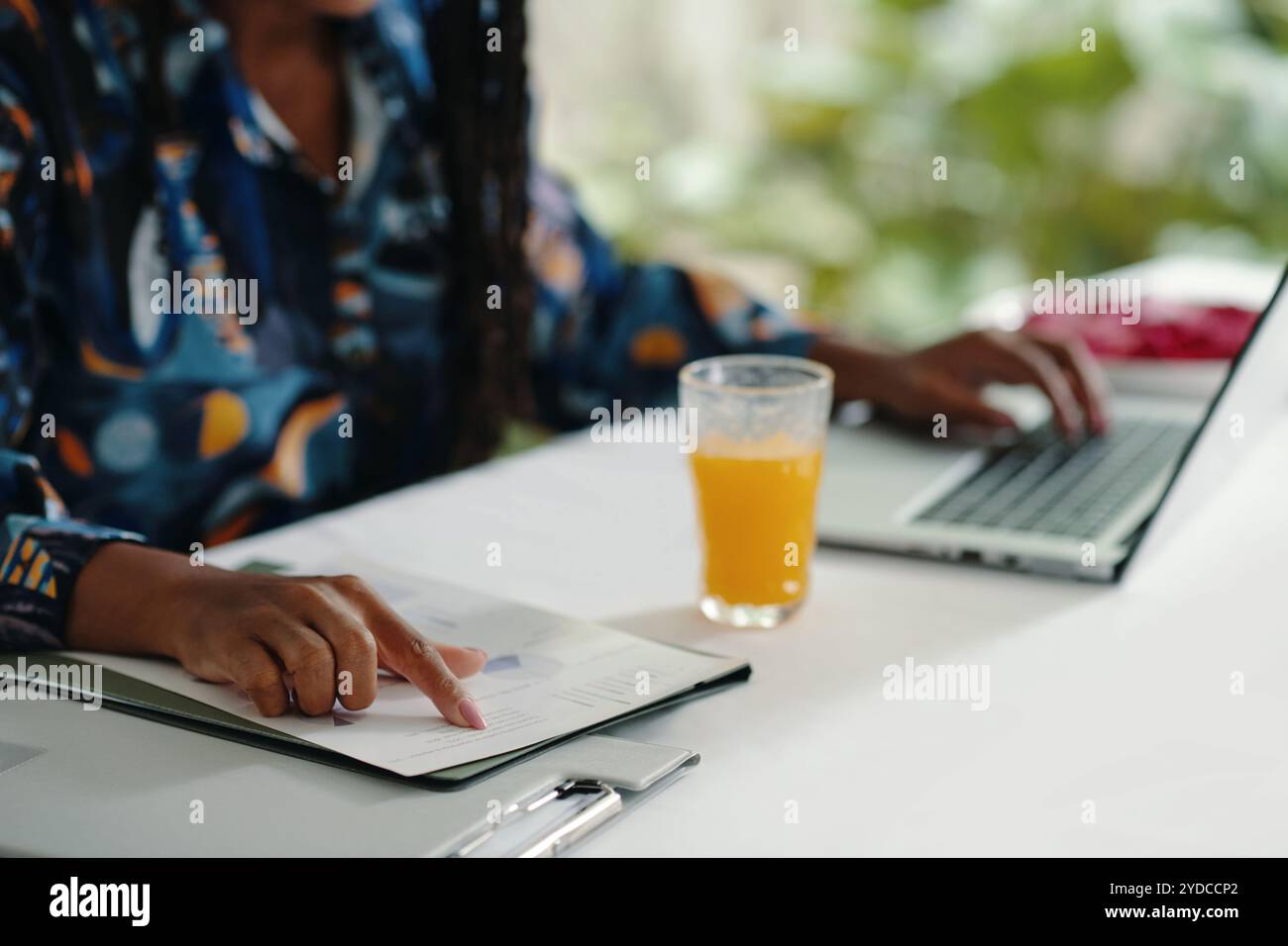 Analyzing Data on Laptop in Office Setting Stock Photo - Alamy