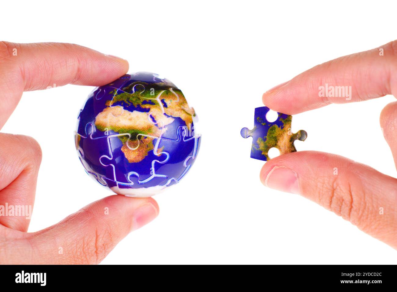 Two hands holding a globe puzzle and a piece, symbolizing problem ...