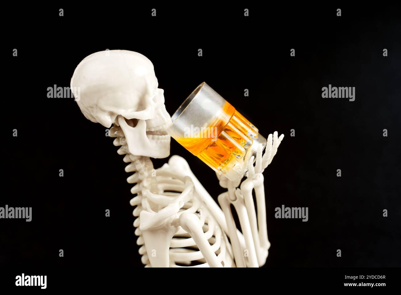 Skeleton sipping drink from mug illustrating alcohol addiction and ...