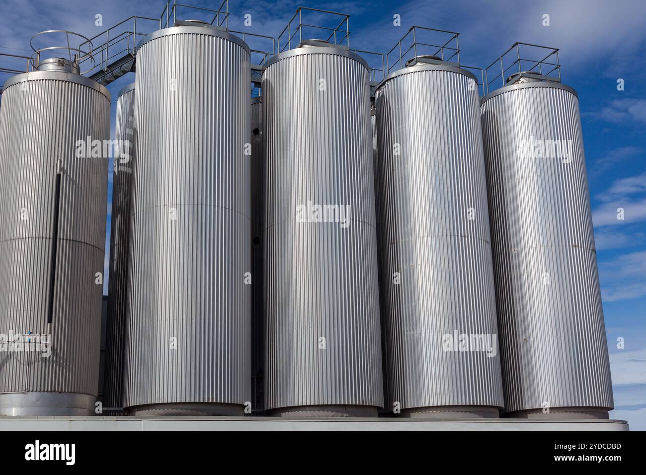 Giant industrial tanks on the bright blue sky Stock Photo - Alamy