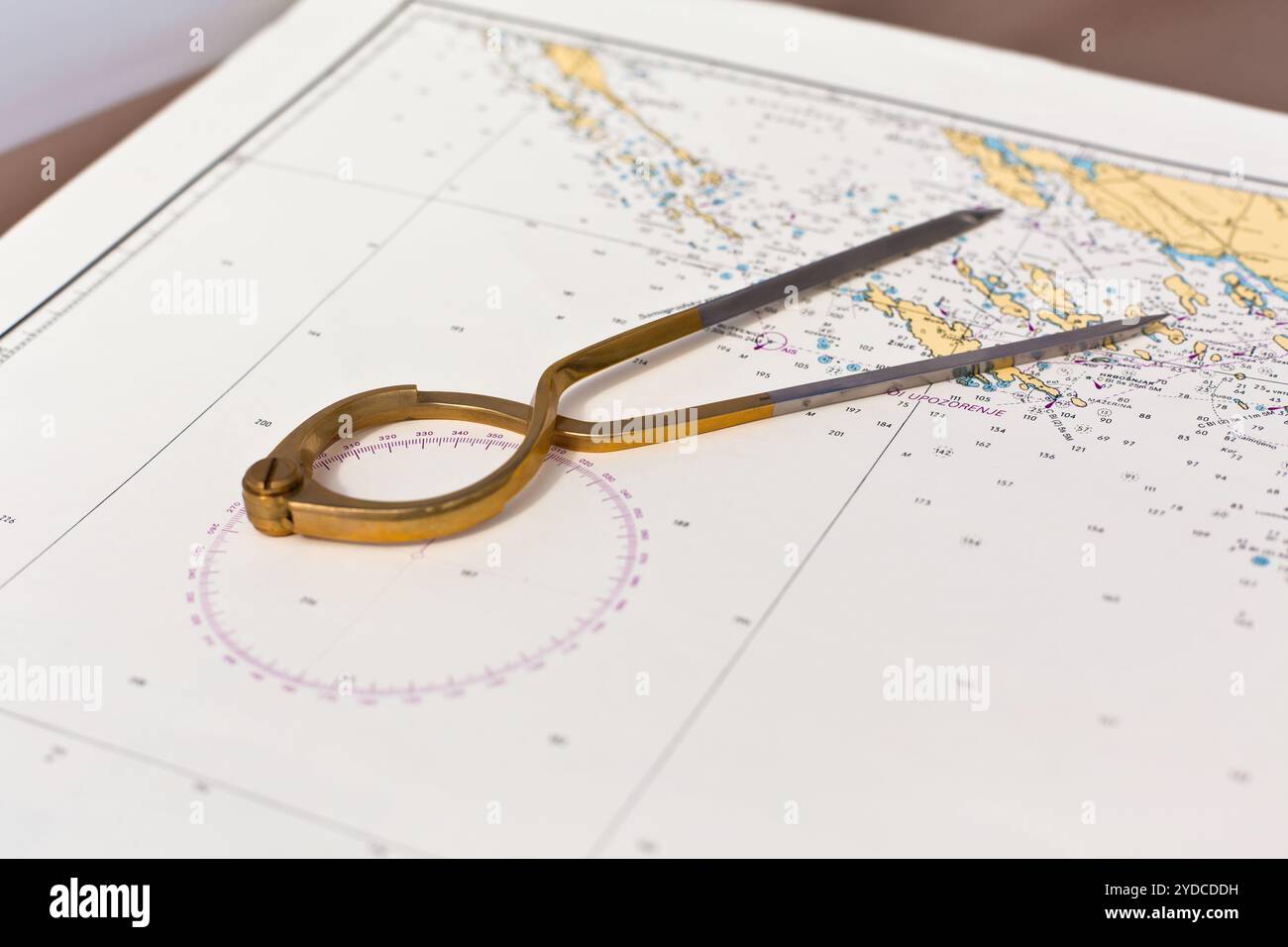 Pair of compasses for navigation on a sea map Stock Photo - Alamy