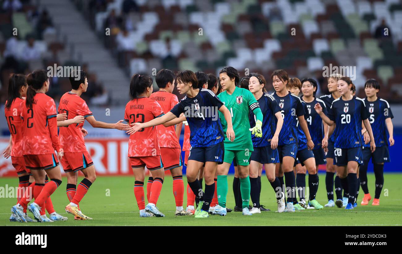 Players of Japan (in blue) and South Korea exchange touches after the ...