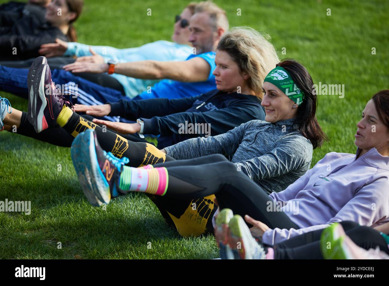Group of people doing abs exercise together. Ukrainian athletes doing ...