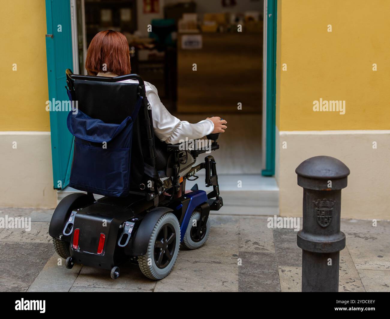 Woman in Wheelchair Approaching Inaccessible Storefront Entrance Stock ...