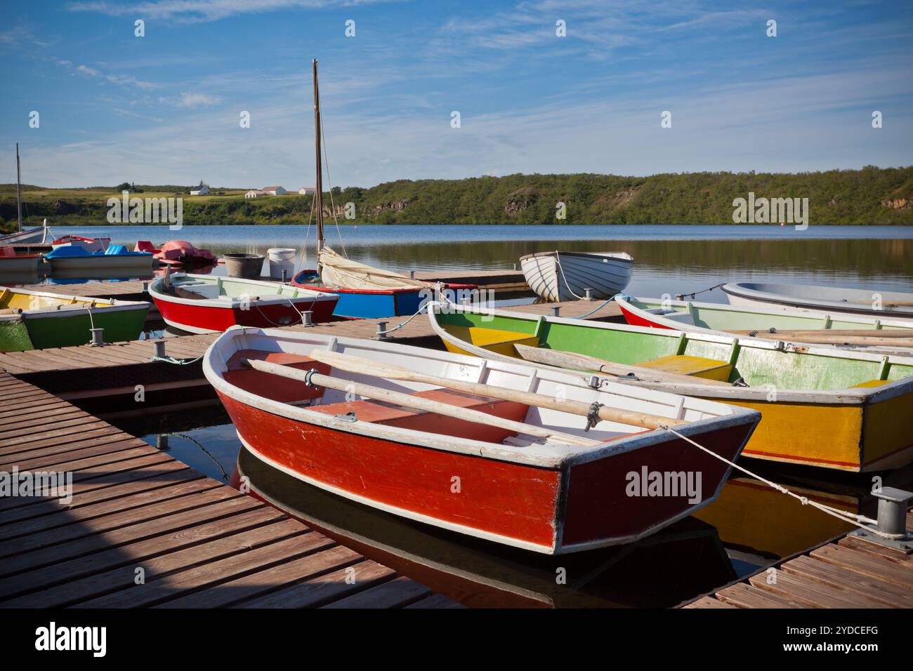 Floating Color Wooden Boats with Paddles in a Lake Stock Photo - Alamy