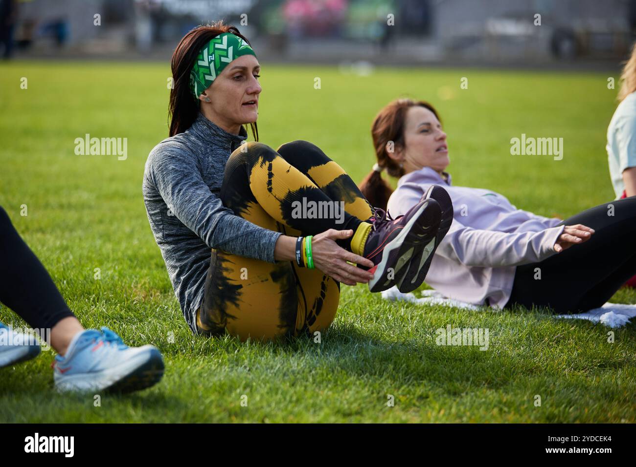 Women doing abs exercises outdoor. Group functional workout in Kyiv ...