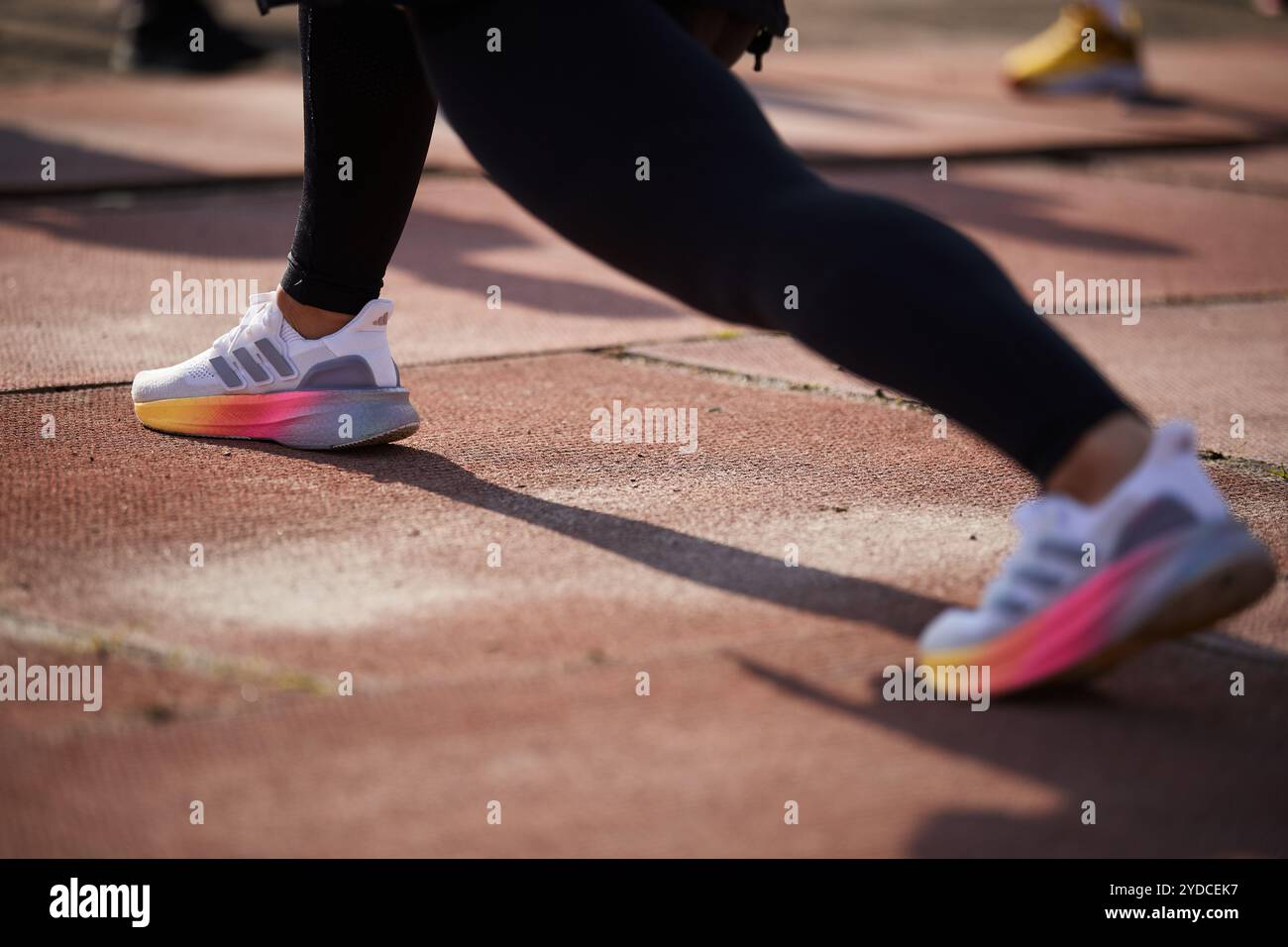 Female athlete stretching wearing modern Adidas Boost sneakers on ...
