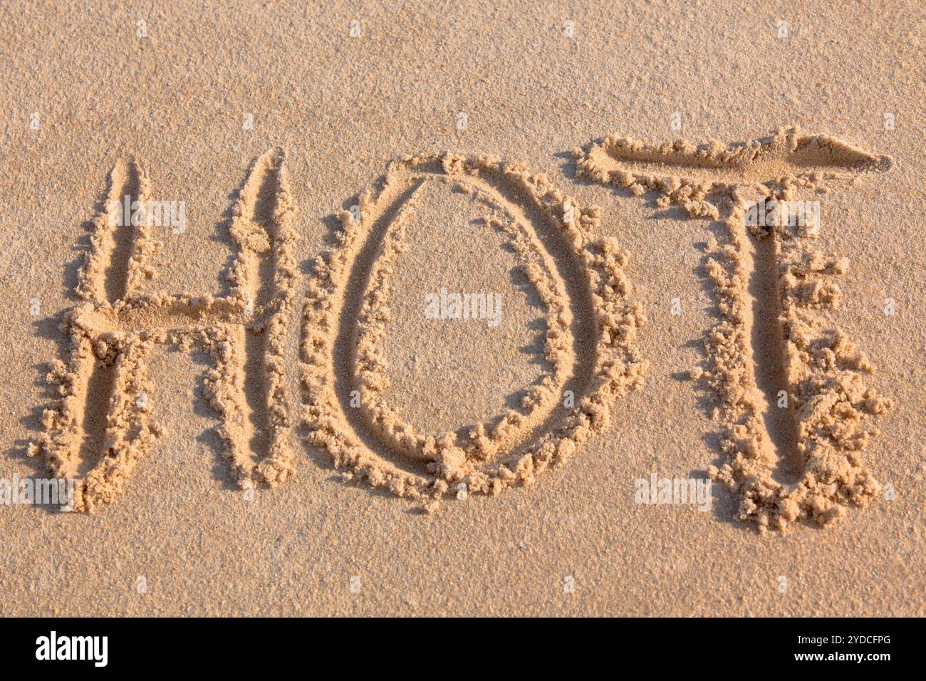 Word hot written on beach sand Stock Photo - Alamy