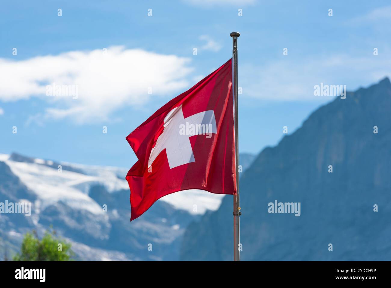 Swiss flag against Alps mountains Stock Photo - Alamy